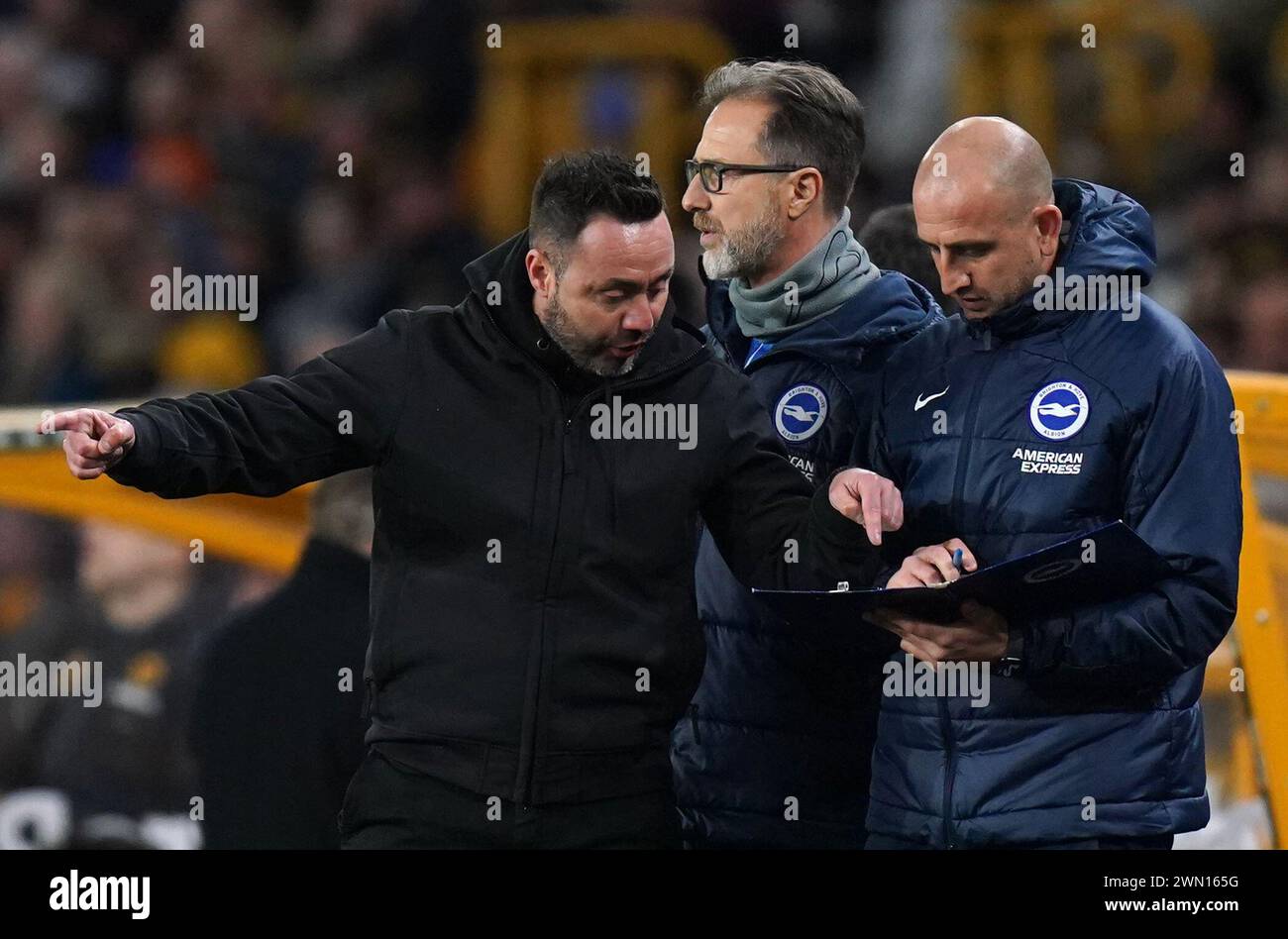 Brighton and Hove Albion manager Roberto De Zerbi (left) with coaches ...
