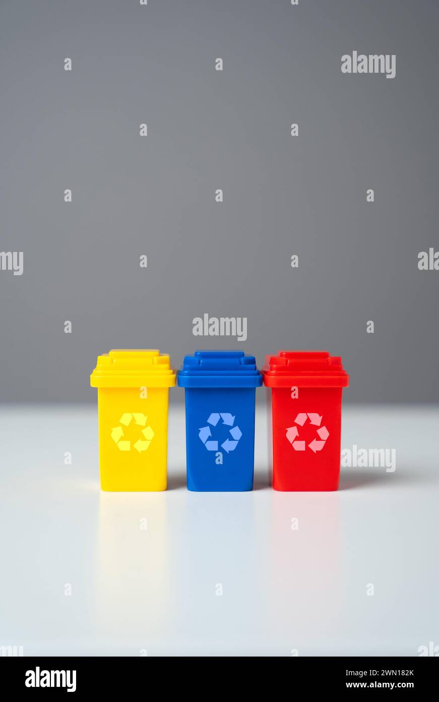 Multi-colored waste recycling bins. Circular economy. Selling recycled ...