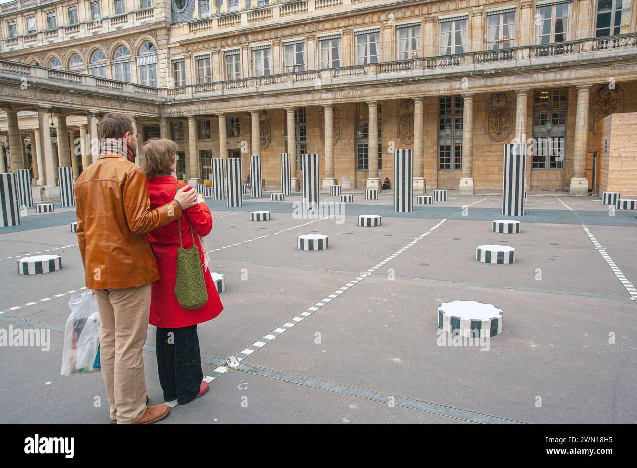rear view of a young couple looking at the courtyard of the Palais ...