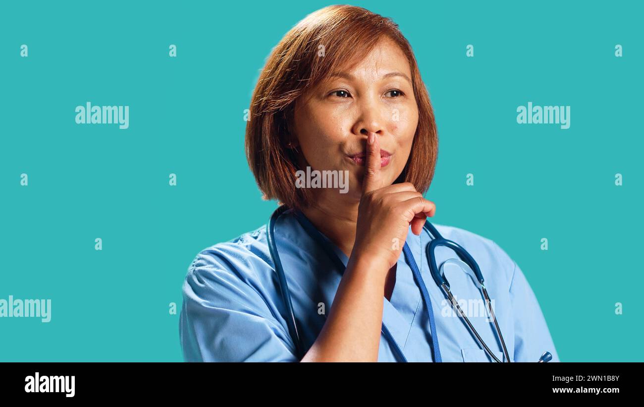 Asian woman shushing hi-res stock photography and images - Alamy