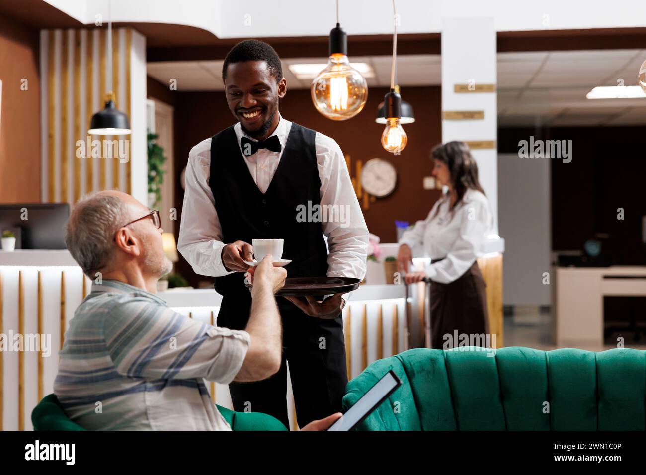 Female hotel employee helping guest hi-res stock photography and images ...