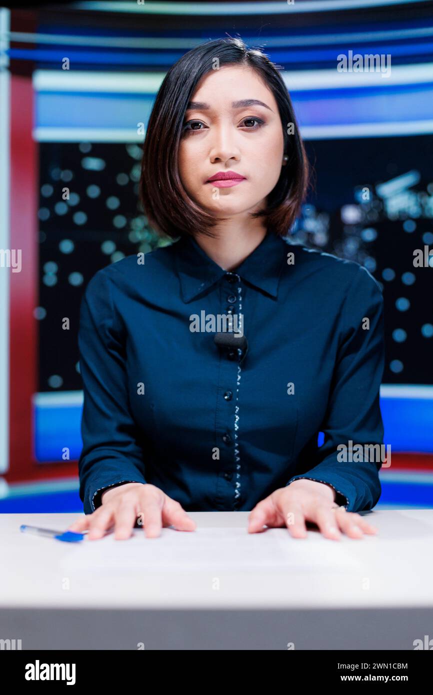 Presenter on midnight news show addressing media outlets information ...