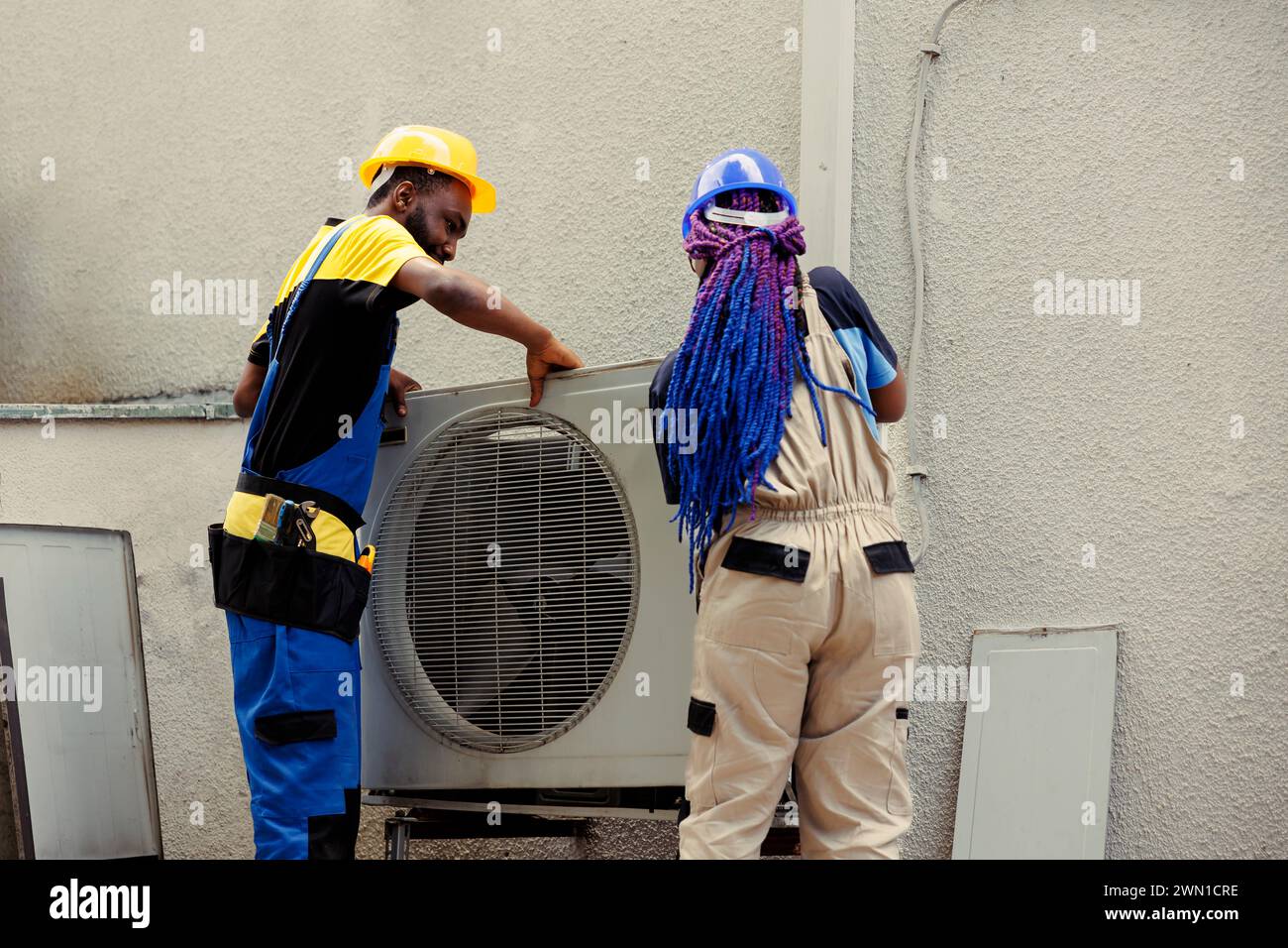 African american expert repairmen pulling apart air conditioner panel ...