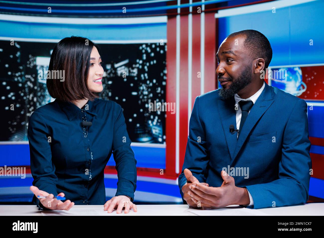 Two reporters broadcasting live information on international television ...