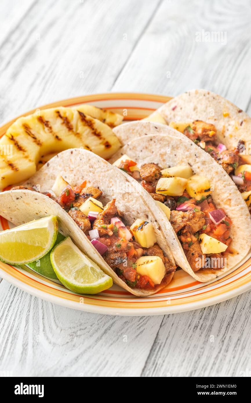 Tacos al pastor mexican dish with pork and pineapple Stock Photo - Alamy