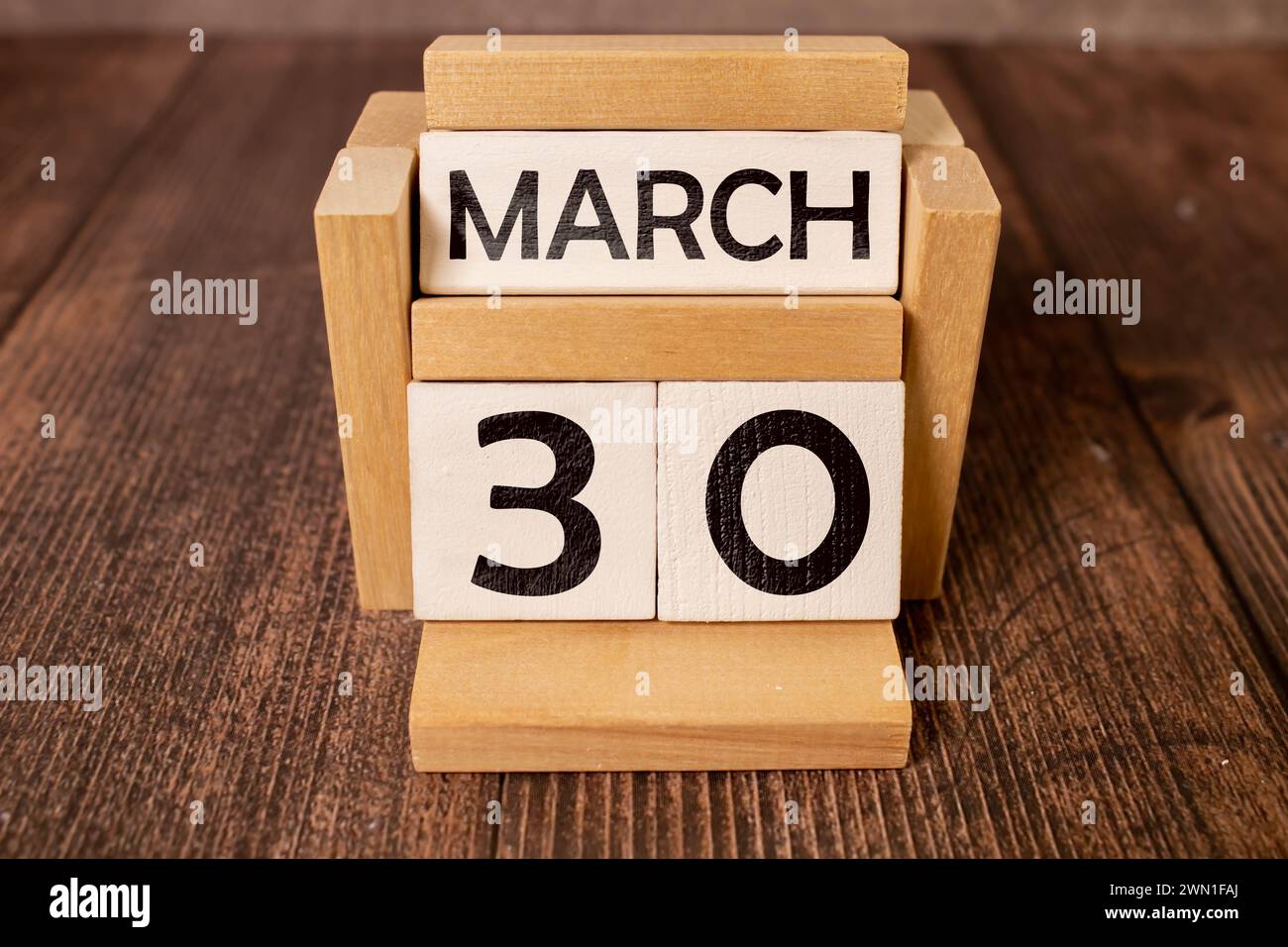 March 30th. Day 30 of month, calendar on table with yellow background ...