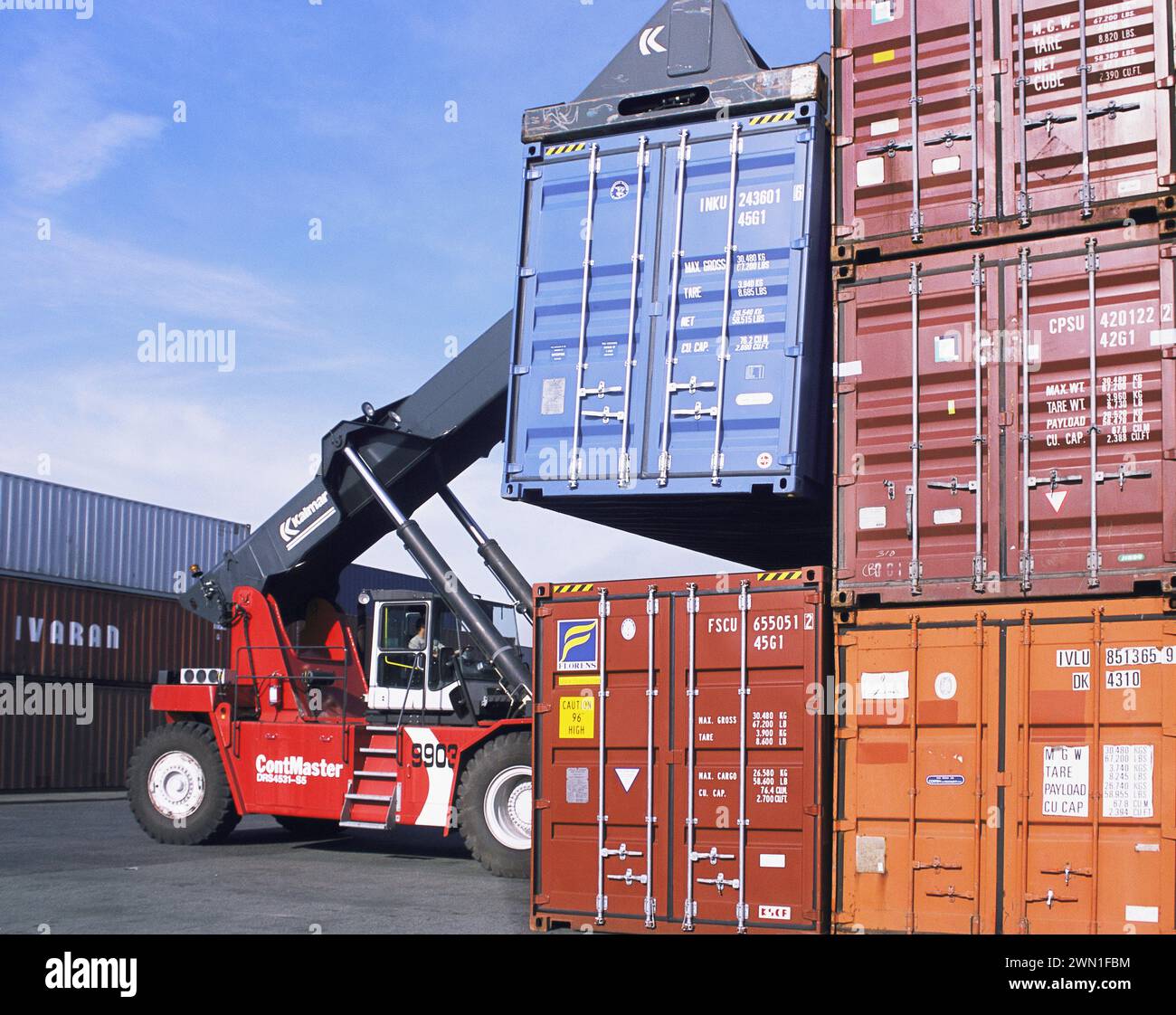 Forklift truck stacking heavy containers. Tariffs trade war. Foreign ...