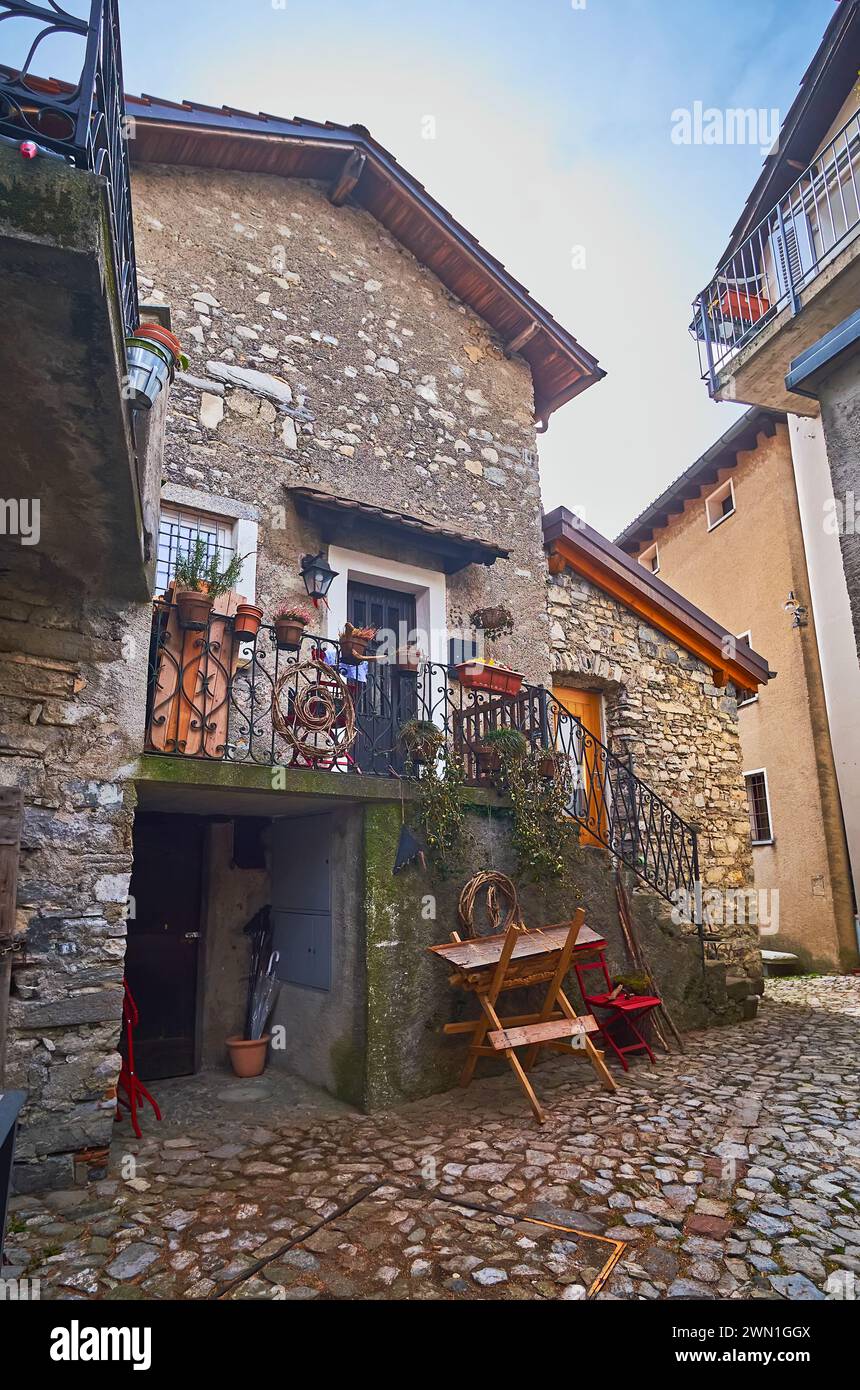 The tiny yard, surrounded with historic stone houses in village of Bre ...