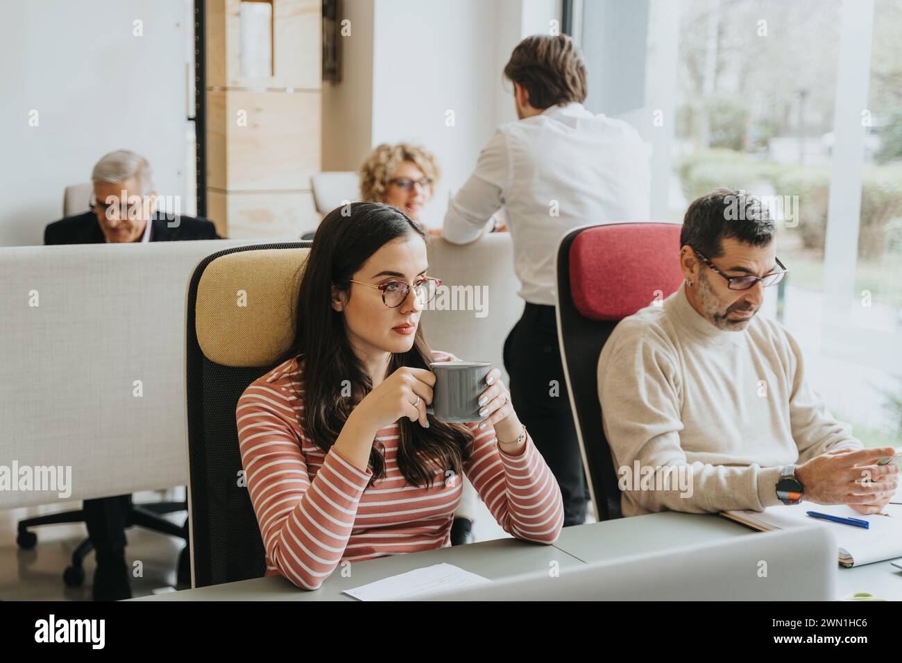 Successful group of multi generational colleagues discussing creative ...