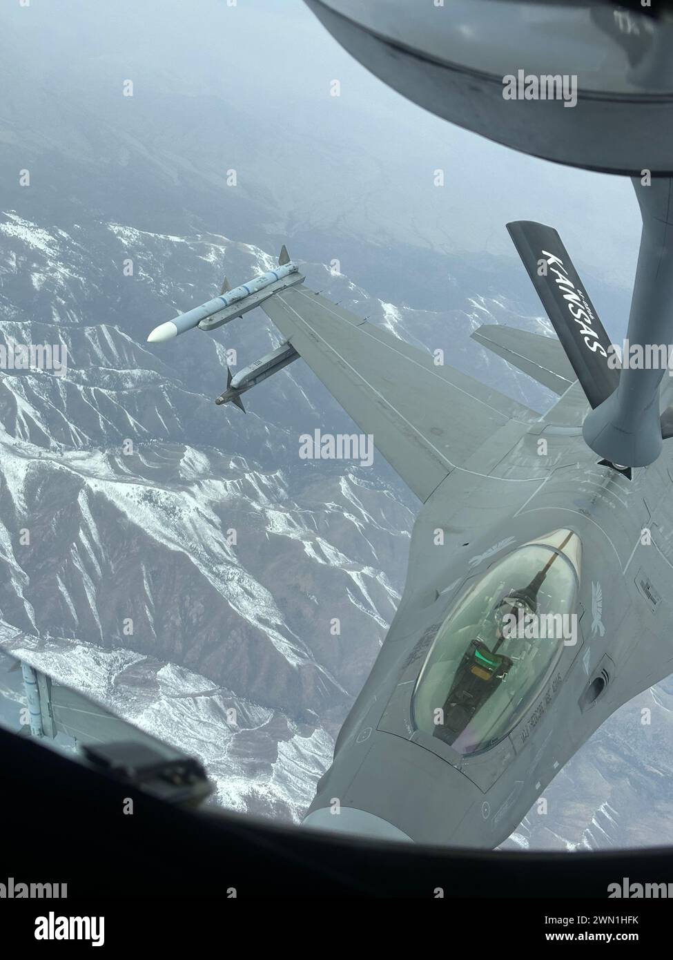U.S. Air National Guard KC-135 Stratotanker refuels an aircraft mid ...