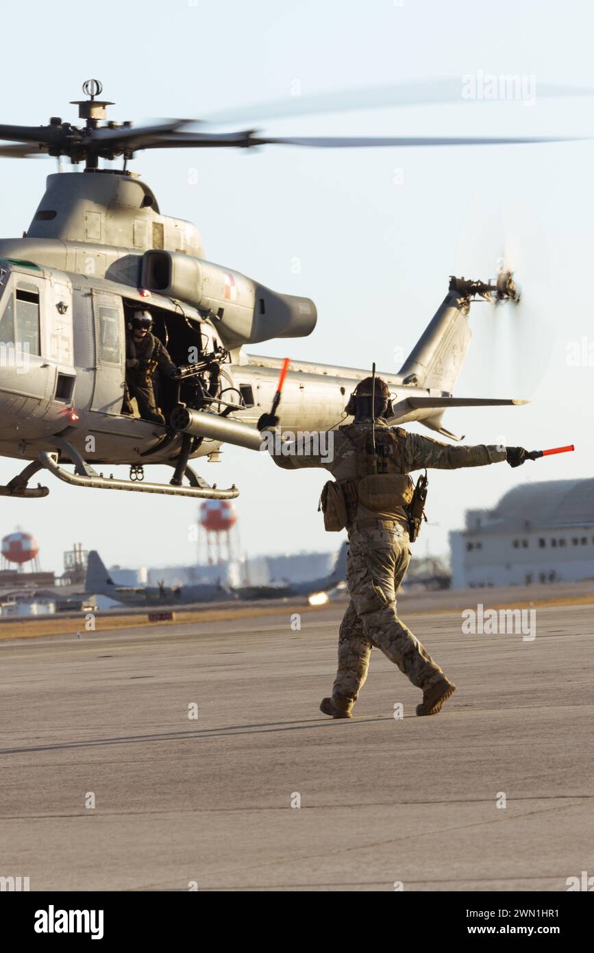 A U.S. Air Force SSgt Robert Patterson, an aircraft marshall, guides a ...