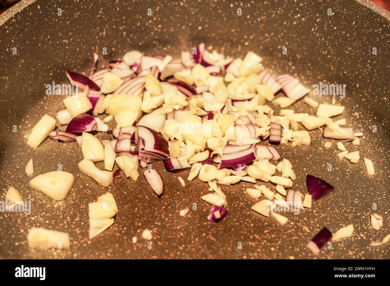 Onion and garlic in the pan Stock Photo - Alamy
