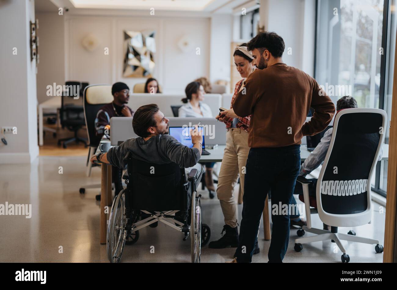 Inclusive work environment: Diverse team engaging in creative office space Stock Photo - Alamy