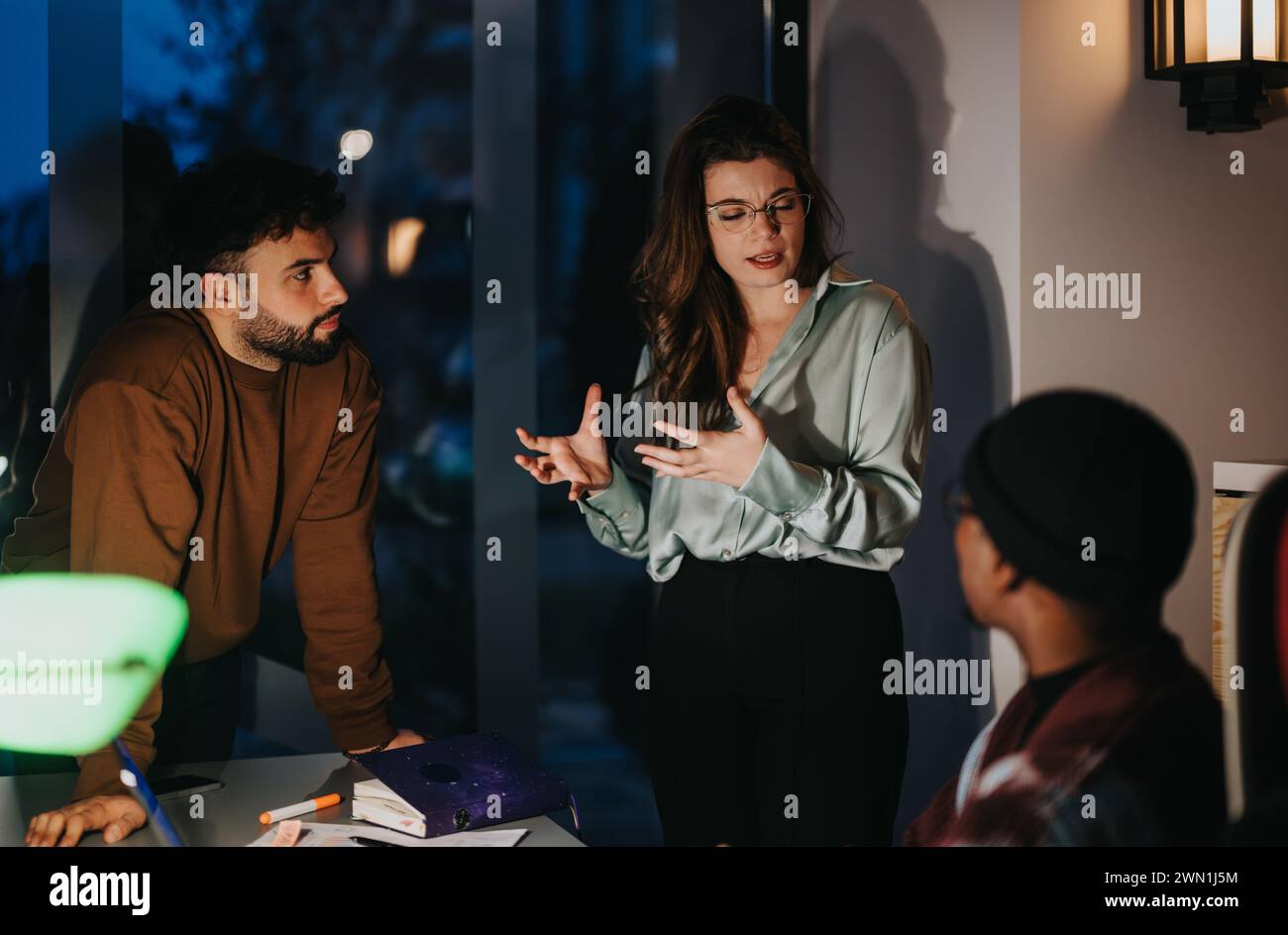Multiracial team of business colleagues engaging in a dynamic discussion Stock Photo - Alamy