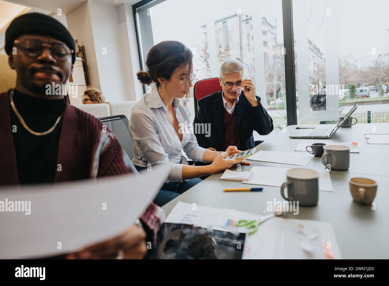 Multicultural, cross generational, business team engaging in a ...