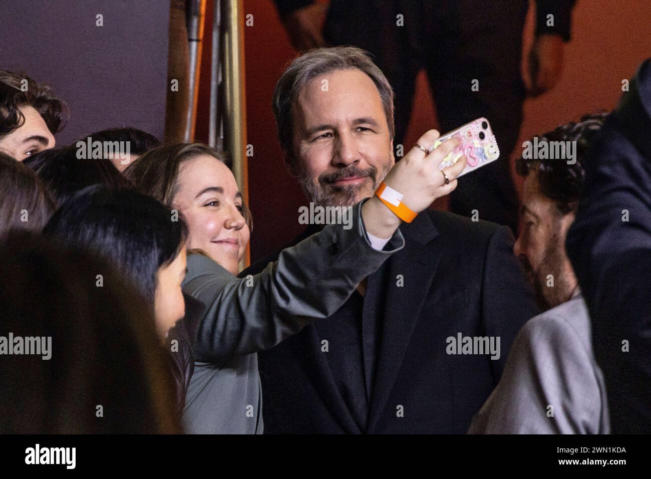 Director Denis Villeneuve, center, poses with a fan as he arrives at ...