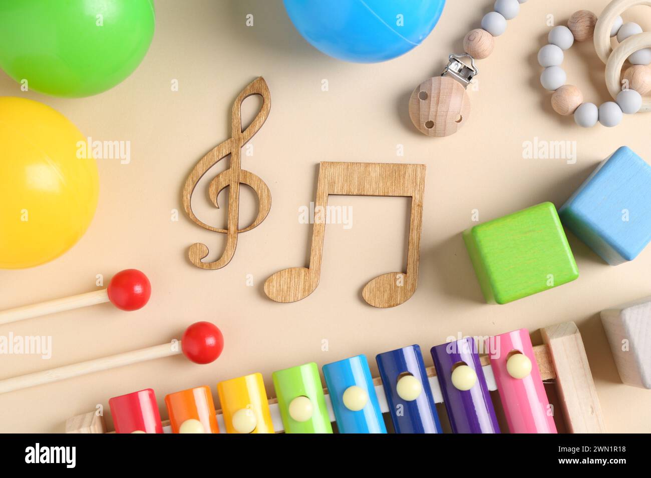 Baby song concept. Wooden notes, kids xylophone and toys on beige ...