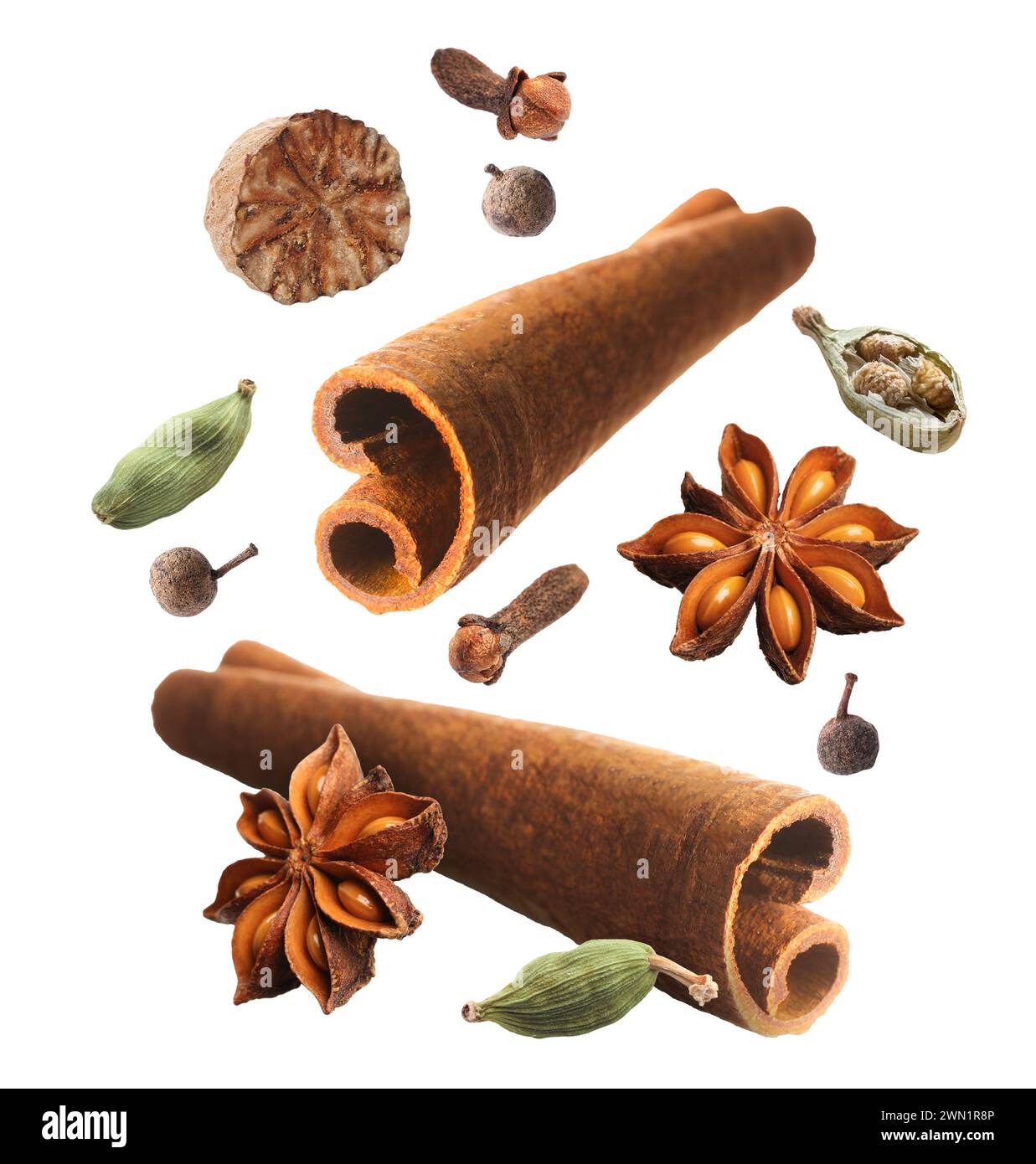 Cinnamon sticks and other aromatic spices falling on white background ...