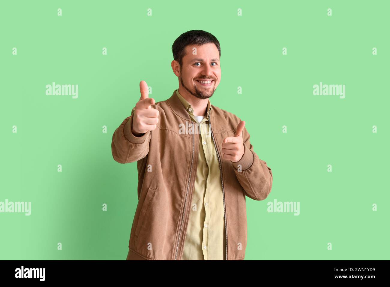 Positive young man pointing viewer hi-res stock photography and images ...