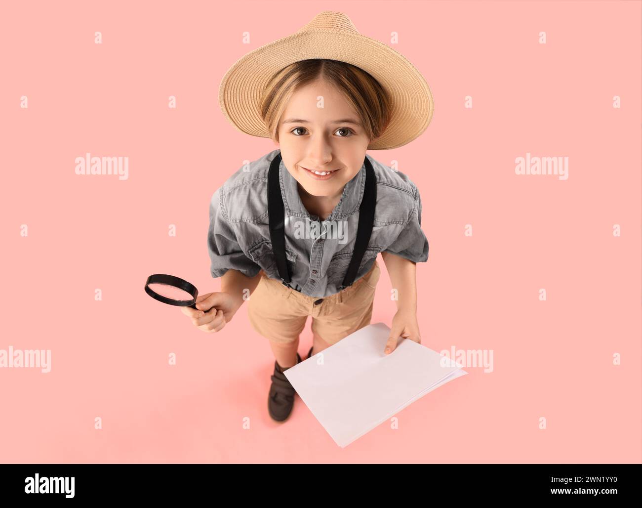 Little actor with magnifier and film script on pink background Stock ...