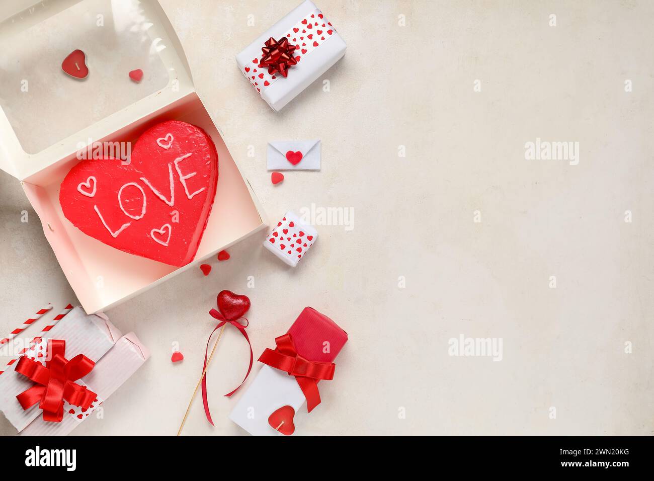 Heart-shaped bento cake with gift boxes on white background. Valentine ...