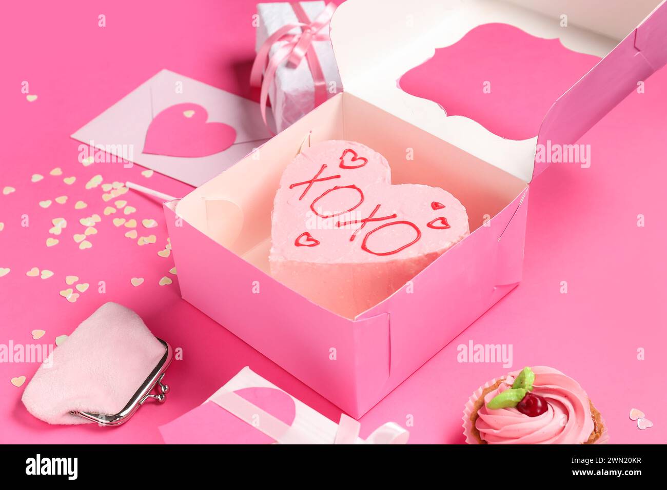 Heart-shaped bento cake with gift boxes, cupcake and love letter on ...