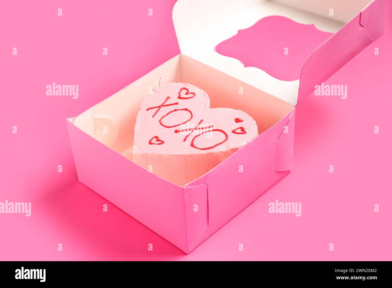 Box with heart-shaped bento cake on pink background. Valentine's Day ...