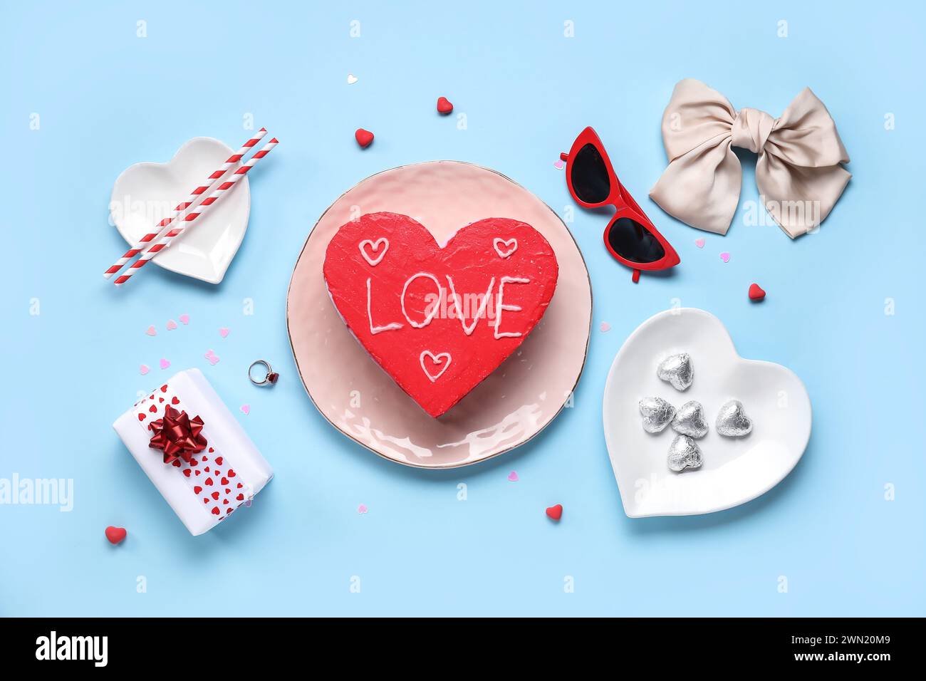 Heart-shaped bento cake with gift box, chocolate candies and ring on ...