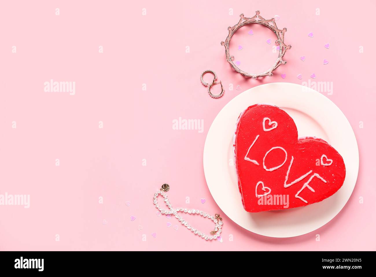 Heart-shaped bento cake with jewelry on pink background. Valentine's ...
