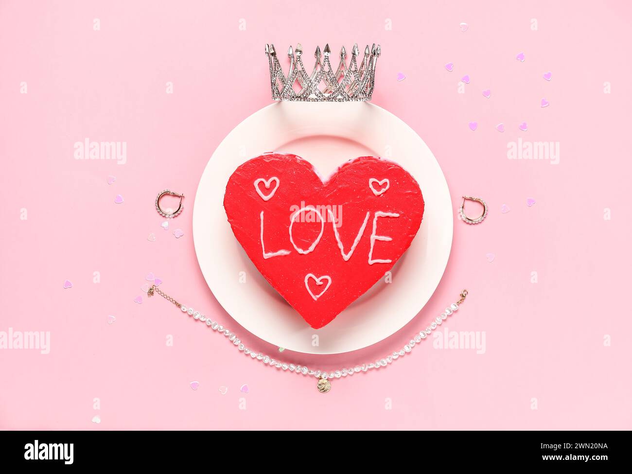 Heart-shaped bento cake with jewelry on pink background. Valentine's ...