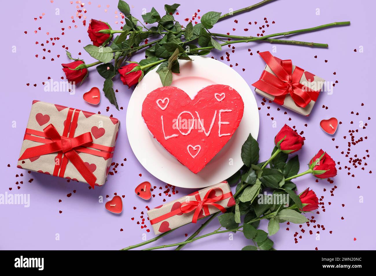 Heart-shaped bento cake with gift boxes, candles and beautiful roses on ...