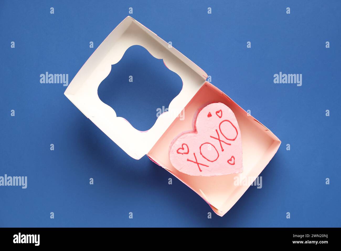 Box with heart-shaped bento cake on blue background. Valentine's Day ...