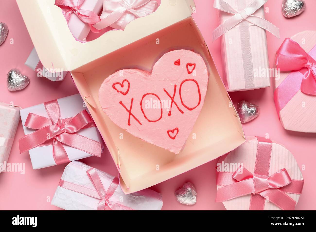 Heart-shaped bento cake with many gift boxes and chocolate candies on ...