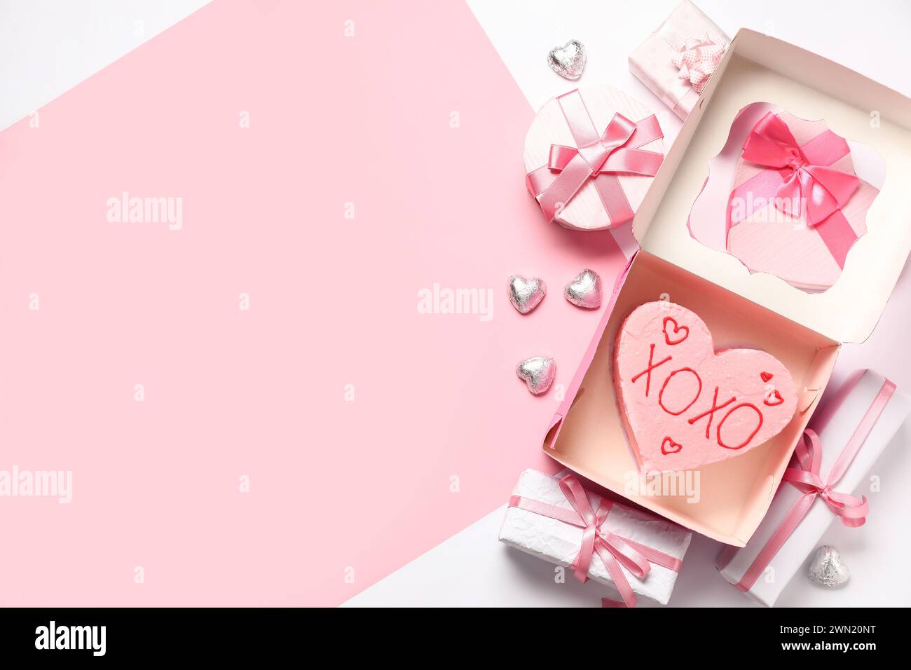 Heart-shaped bento cake with many gift boxes and chocolate candies on ...