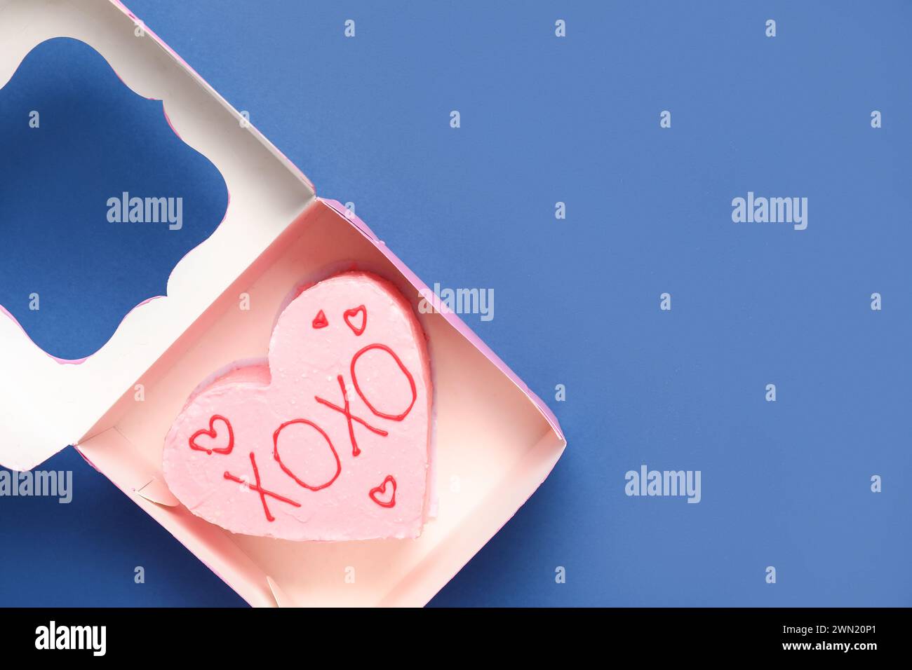 Box with heart-shaped bento cake on blue background. Valentine's Day ...