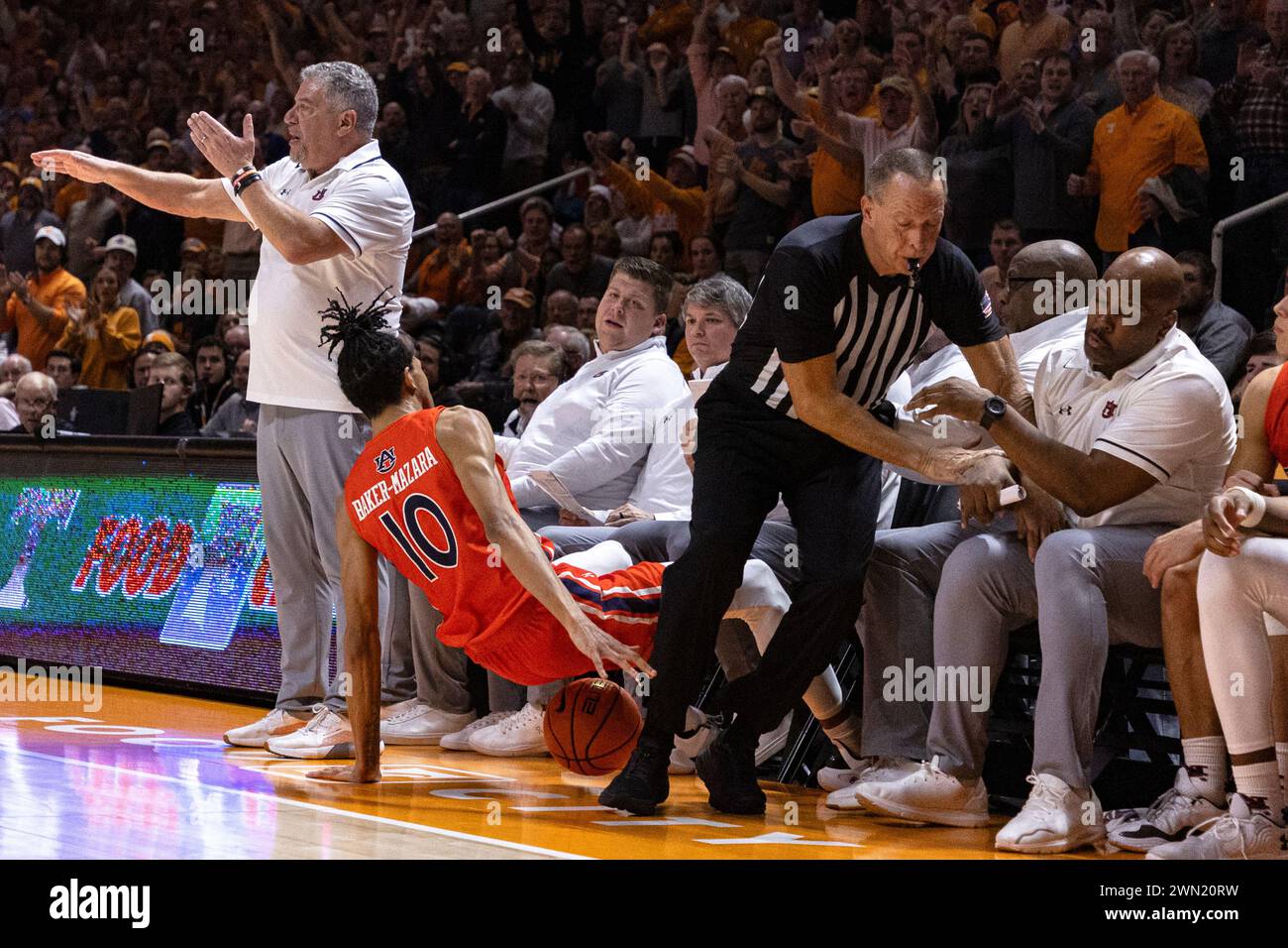 Auburn guard Chad Baker-Mazara (10) collides with an official as he ...