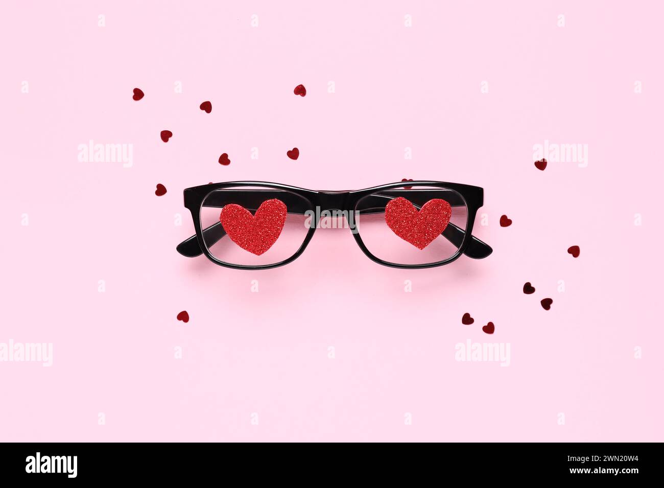 Composition with stylish eyeglasses and red hearts on pink background ...