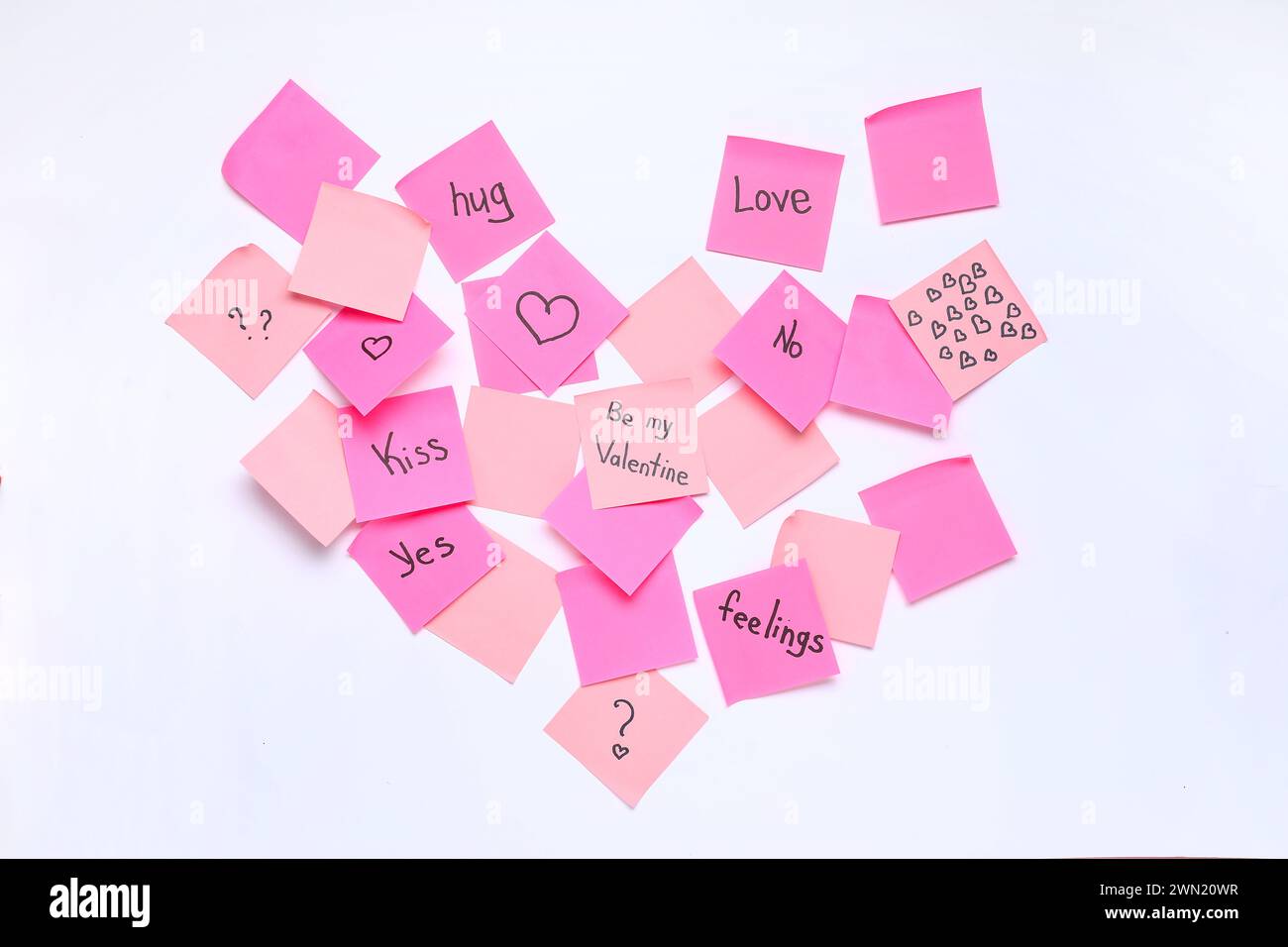 Heart made of pink sticky notes with messages on white background ...