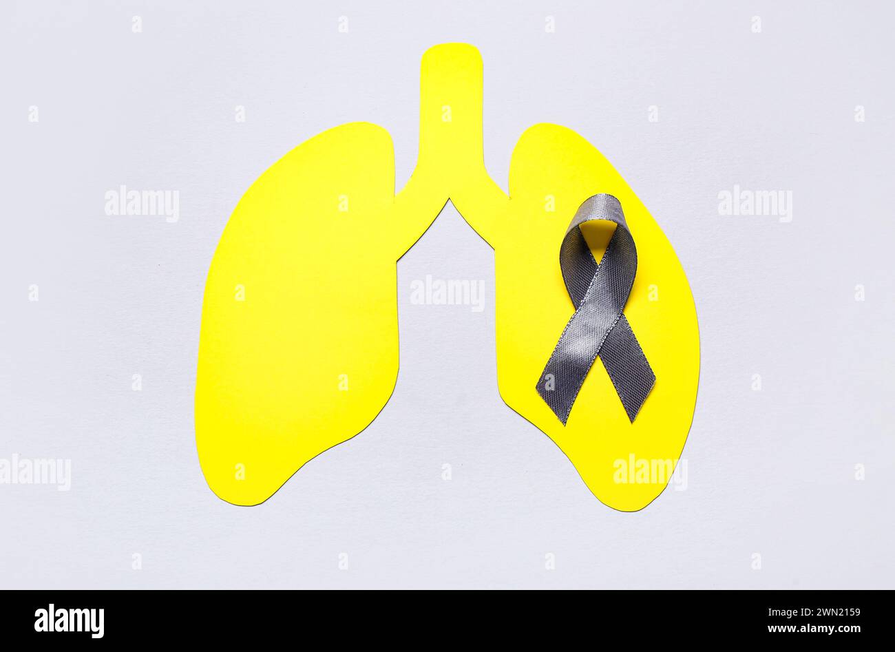 Yellow paper lungs with ribbon on grey background Stock Photo - Alamy