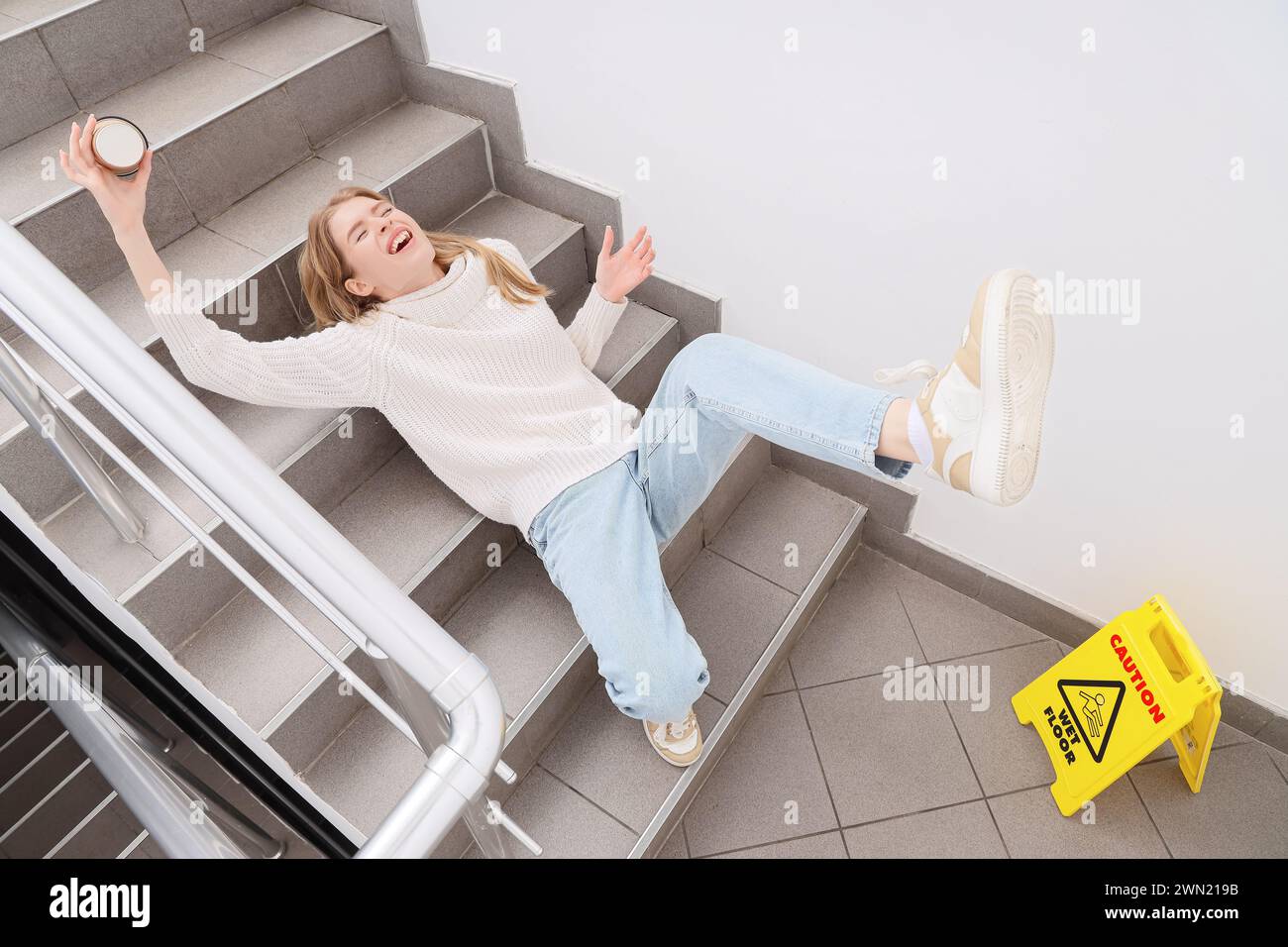 Young woman fell down on wet steps in stairway. Trauma concept Stock ...