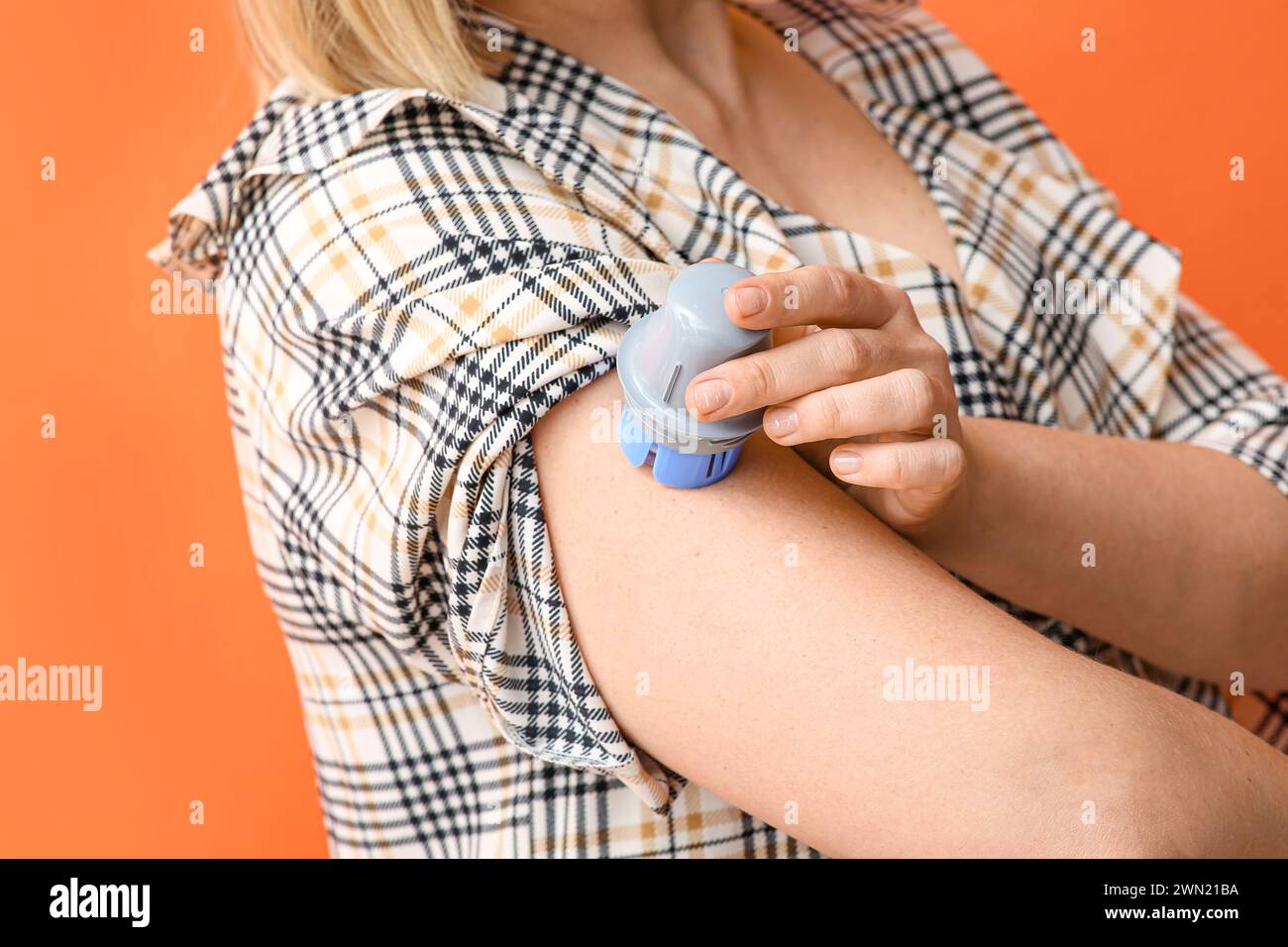 Woman with glucose sensor for measuring blood sugar level and ...