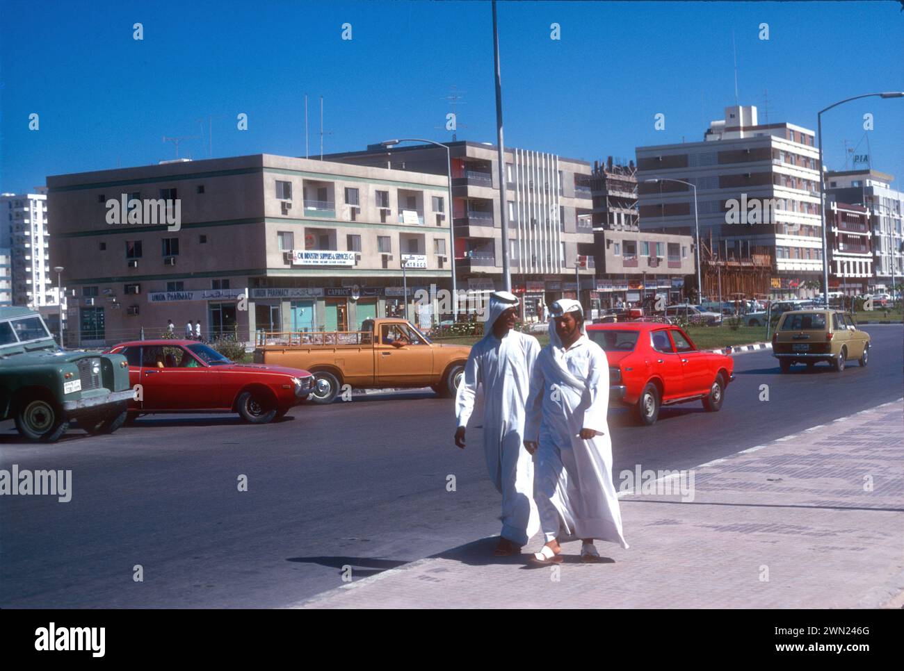 Main street with two Arabs walking, in Abu Dhabi, UAE 1975 Stock Photo - Alamy