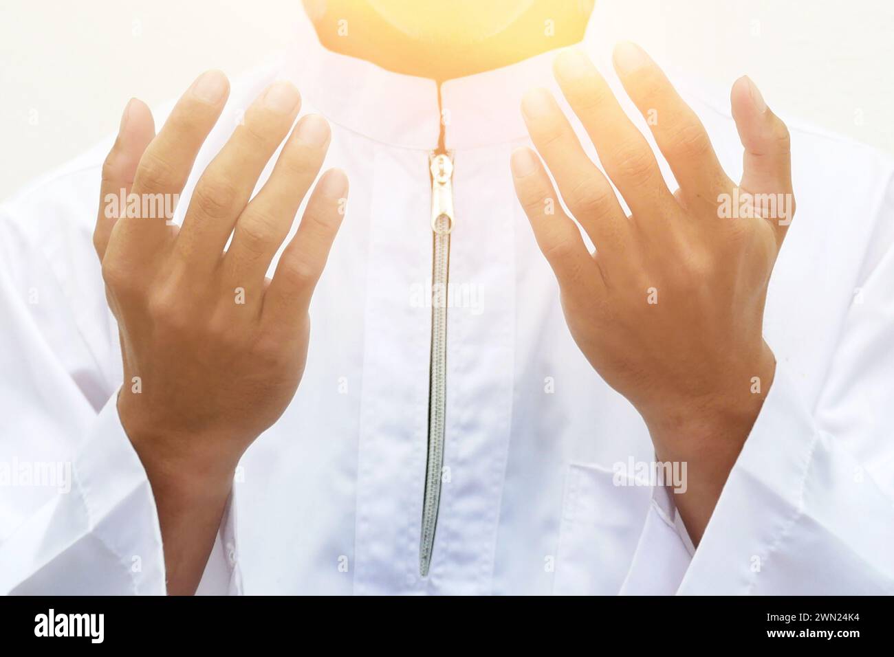 Front view of Muslim man raising hands and praying in mosque, ramadan ...