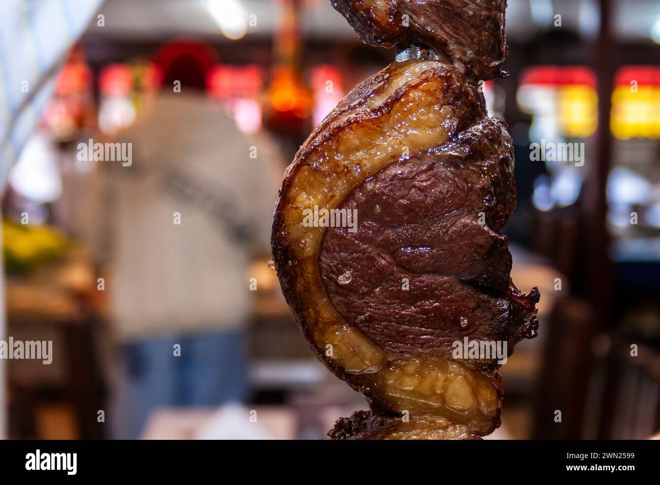 Brazilian style beef ribs Barbecue grill on skewers at a churrascaria ...