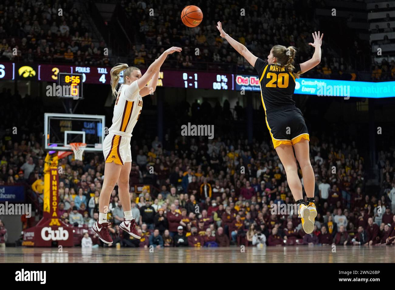 Minnesota forward Mallory Heyer, left, shoots over Iowa guard Kate ...