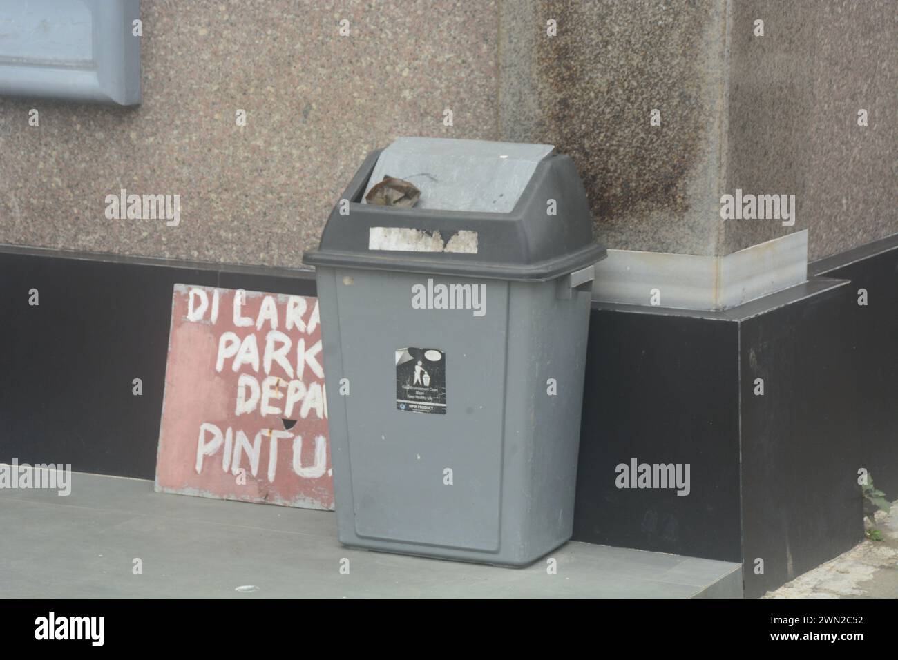 Gray bins are placed on the ground to create a clean environment ...