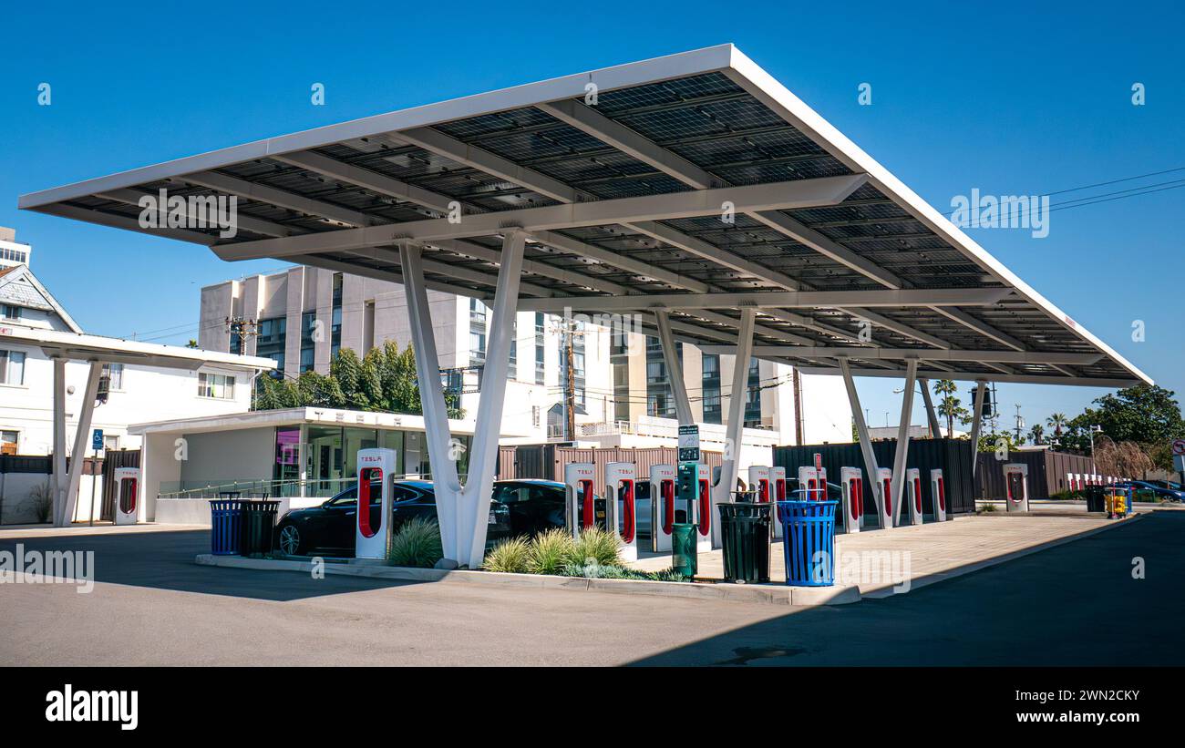 A Tesla Supercharger charging station or charge point beneath large ...