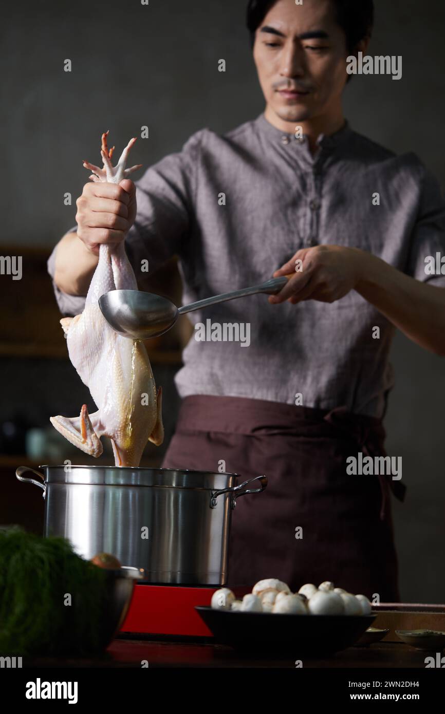 Chinese asian man making chicken hi-res stock photography and images - Alamy