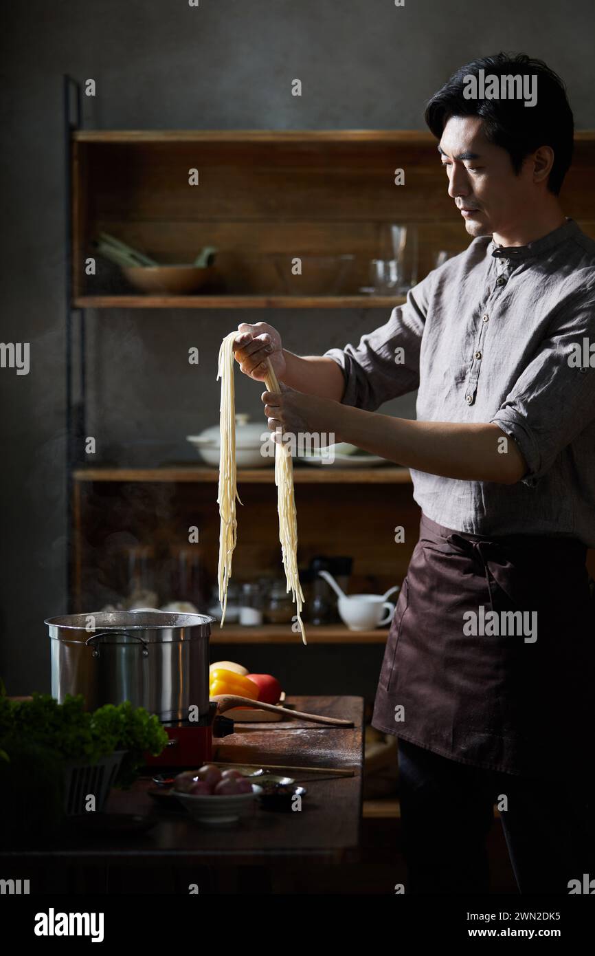 Cook making dishes in the kitchen Stock Photo - Alamy