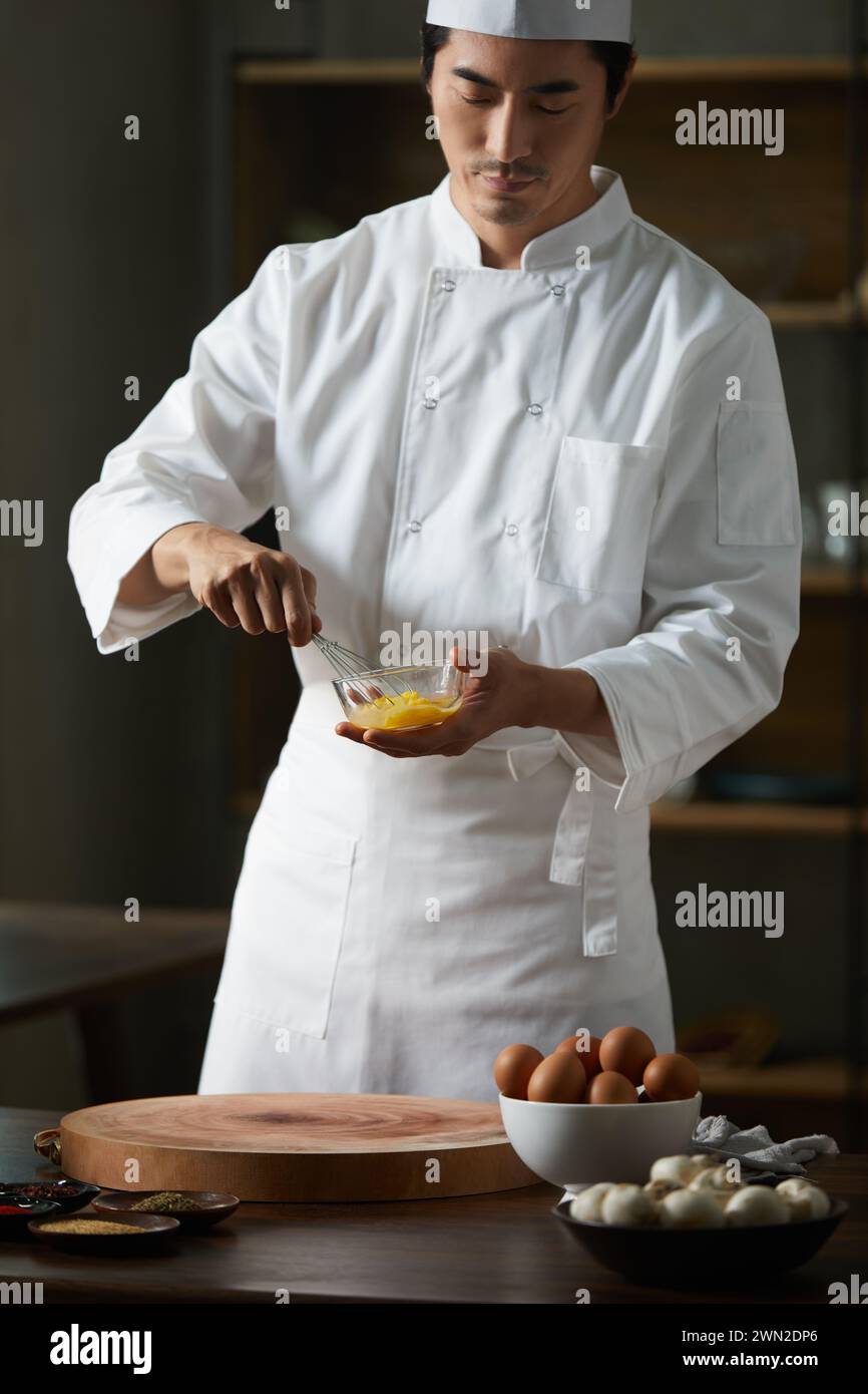 Cook making dishes in the kitchen Stock Photo - Alamy